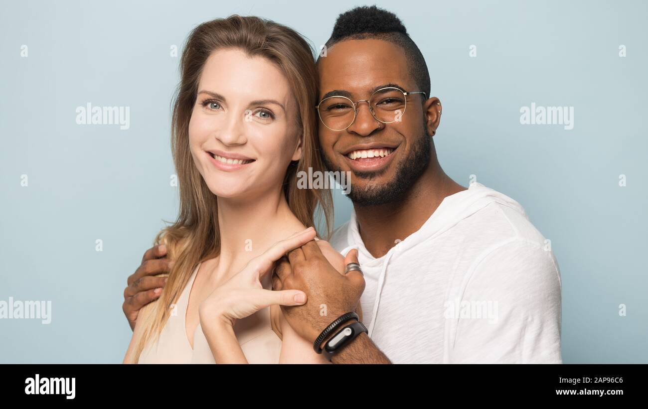 Portrait of happy diverse couple hug making picture in studio Stock ...