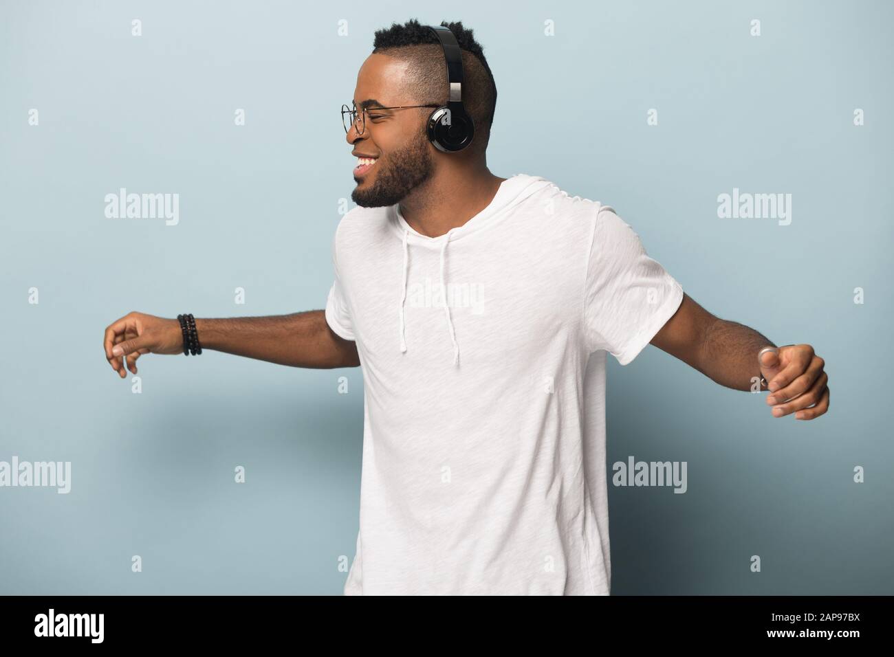 Happy black man listen music in Bluetooth headphones Stock Photo - Alamy