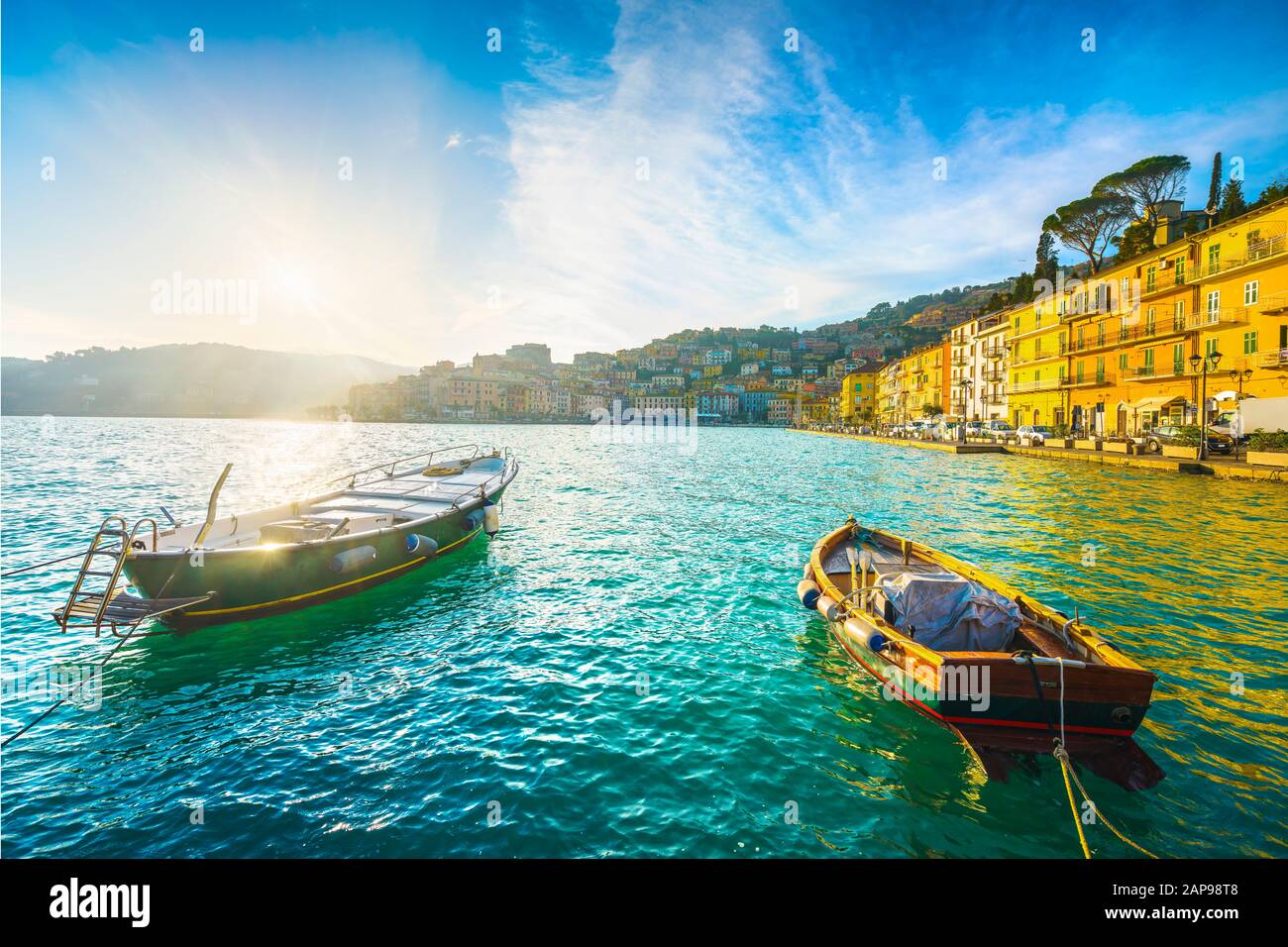 Wooden small boats in Porto Santo Stefano seafront at sunrise, italian ...