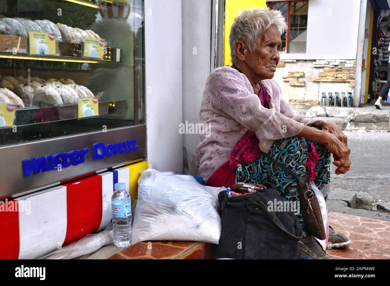 Antipolo City, Philippines - January 18, 2020: Old Filipino woman sit ...