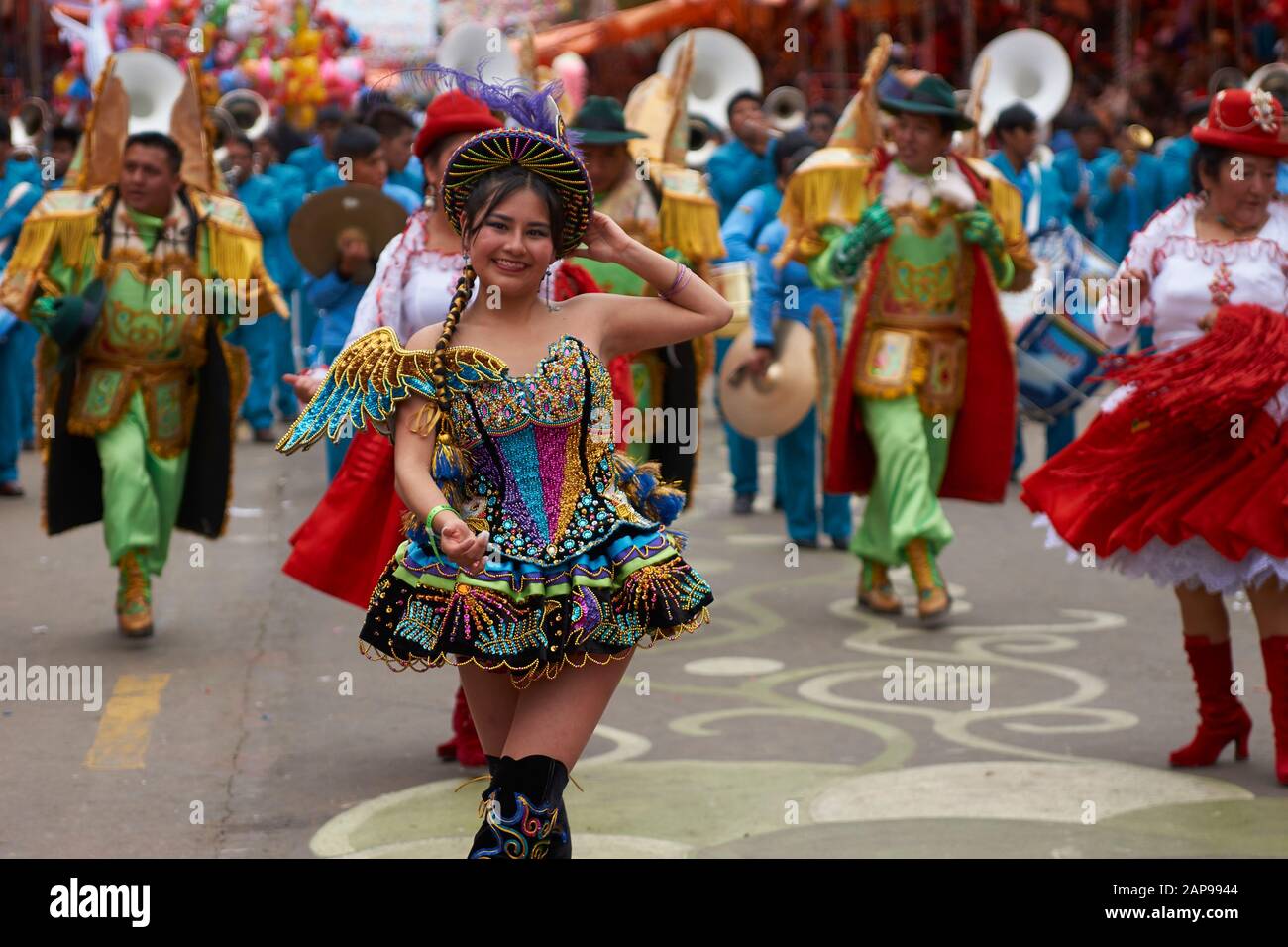 Morenada dance group in colourful outfits parading through the mining ...