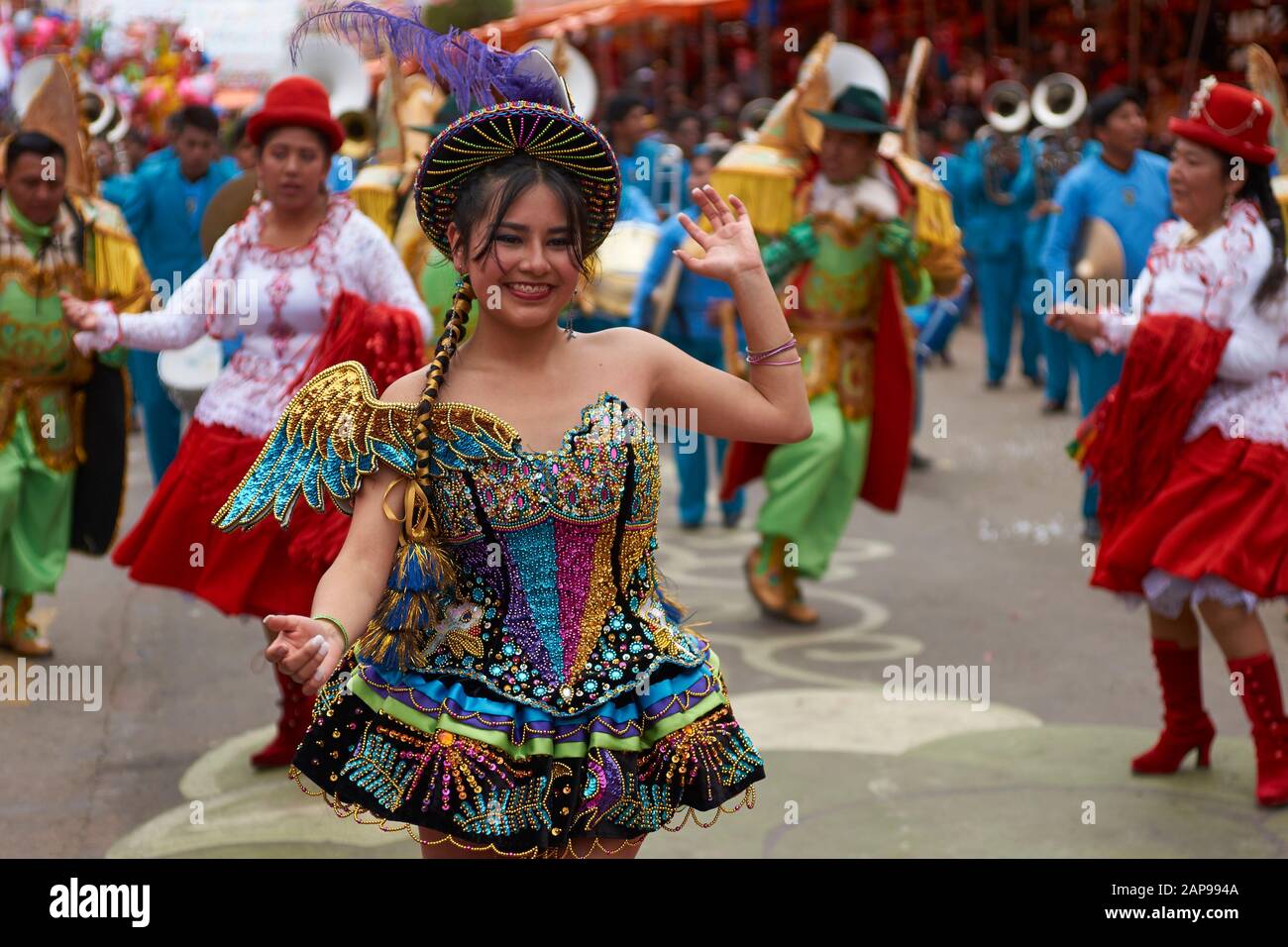 Morenada dance group in colourful outfits parading through the mining ...