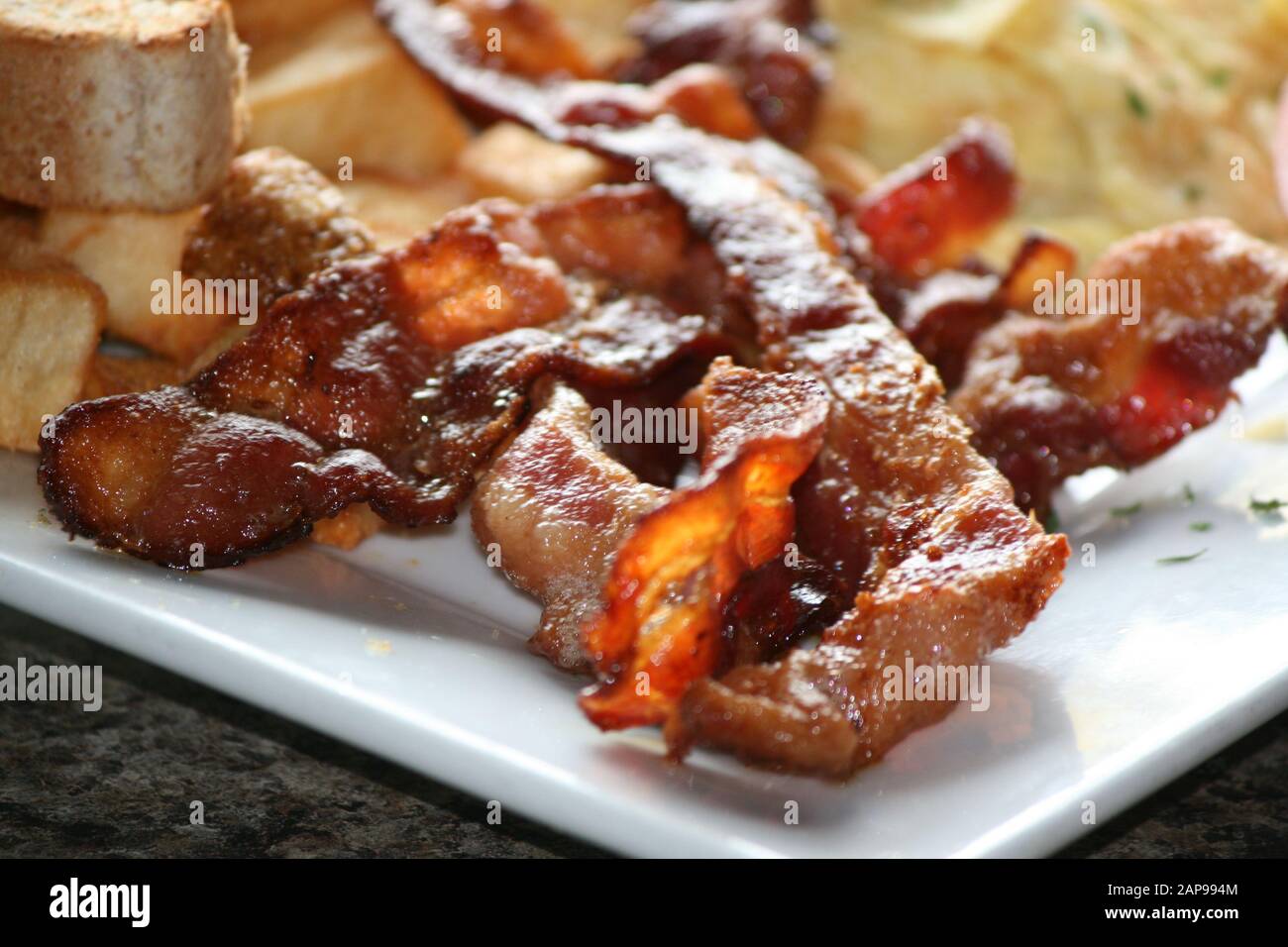 crispy well cooked pork bacon strips fried or grilled with hash browns ...