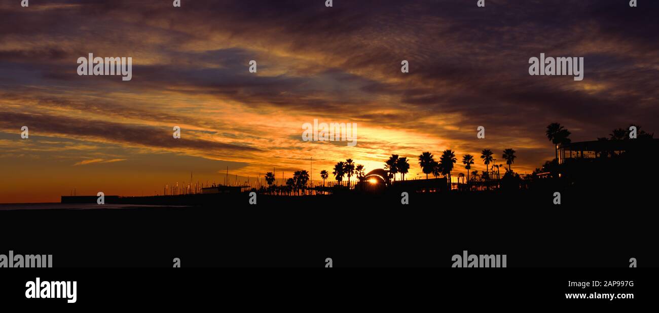 Spectacular sunrise at the beach in Valencia, Spain. The silhouette of ...