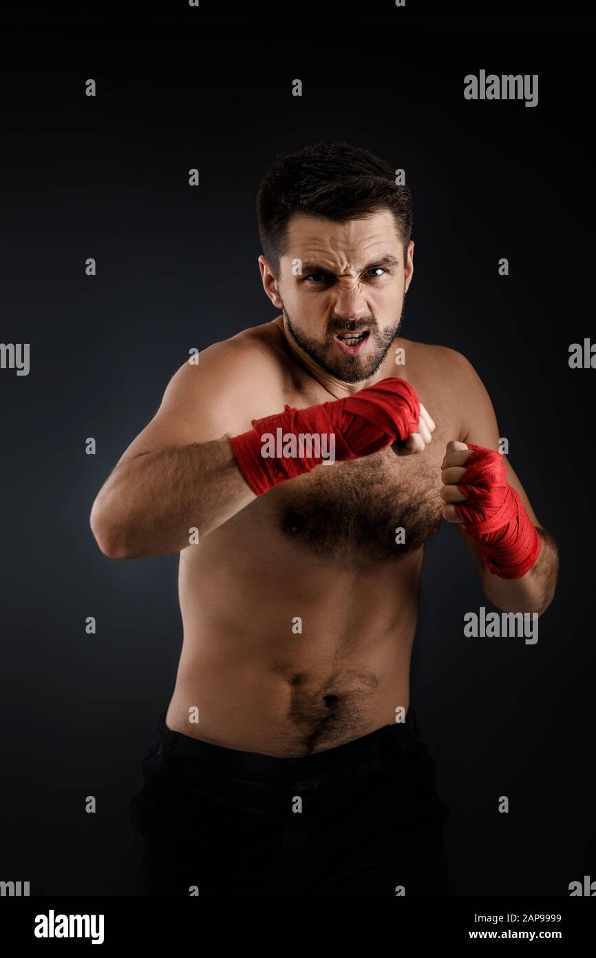 Sportsman boxer throwing a fierce and powerful punch. muscular man on ...