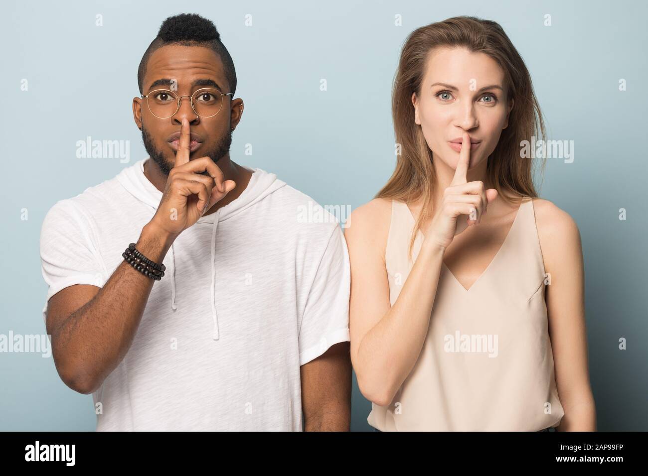 Be quiet hand to lips black hi-res stock photography and images - Alamy