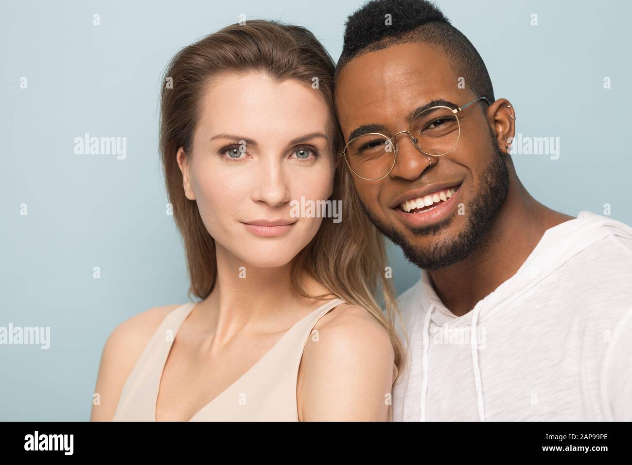 Happy multicultural couple posing for portrait in studio Stock Photo ...