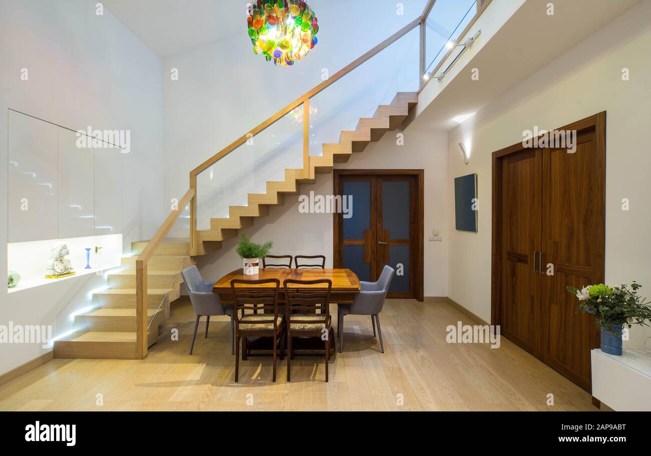 Modern light interior of living room in private house. Staircase. Woden ...