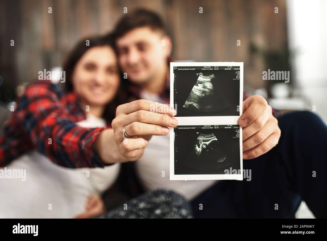 A young married couple awaiting a baby. Beautiful couple lying in the ...