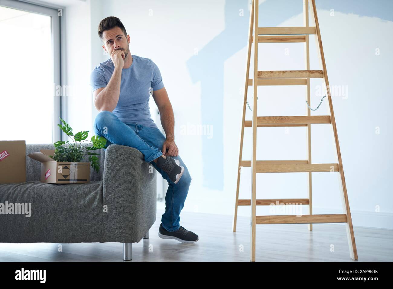 Young man making plans for his new flat Stock Photo - Alamy