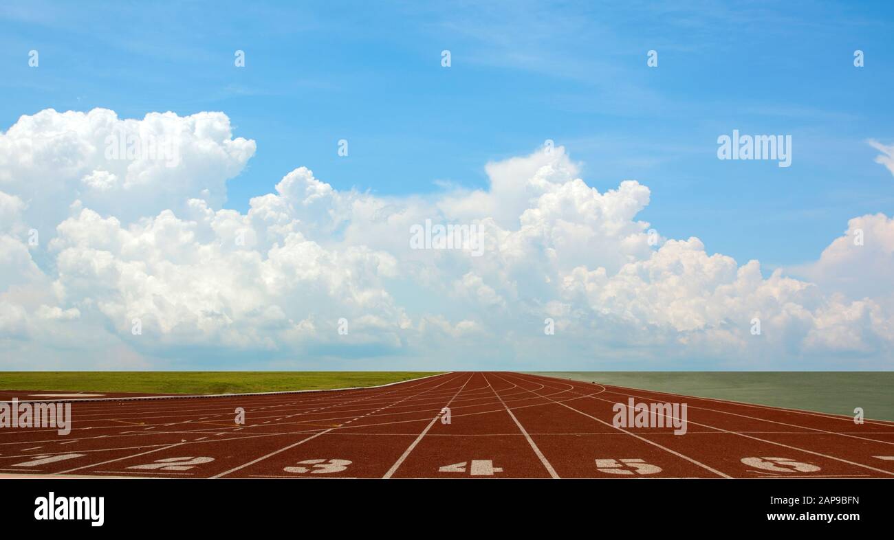Running track with the lanes over sky and clouds Stock Photo - Alamy