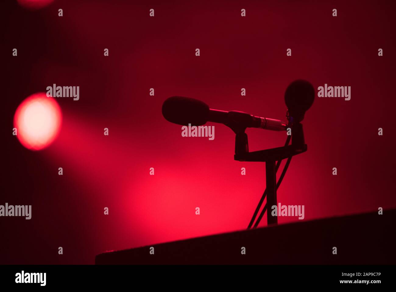Microphone in red stage lights Stock Photo - Alamy