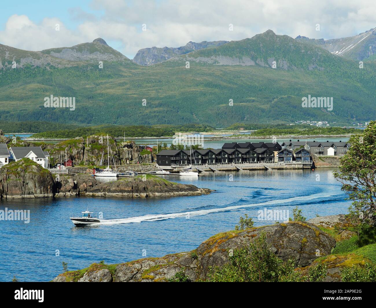 A boat leaving the famous tourist attraction Hamn Village, Senja island ...