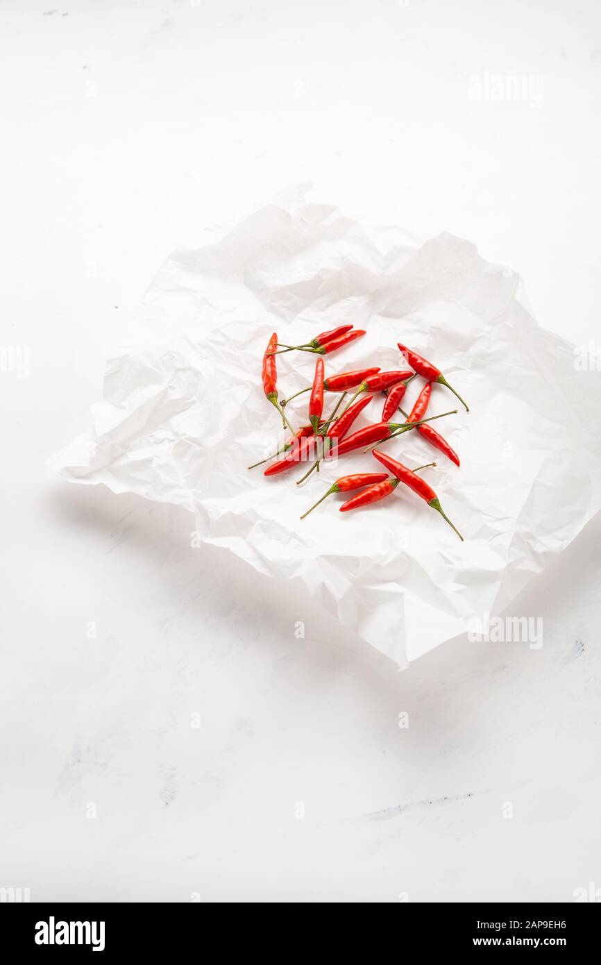 Red chilli pepper on white paper Stock Photo - Alamy