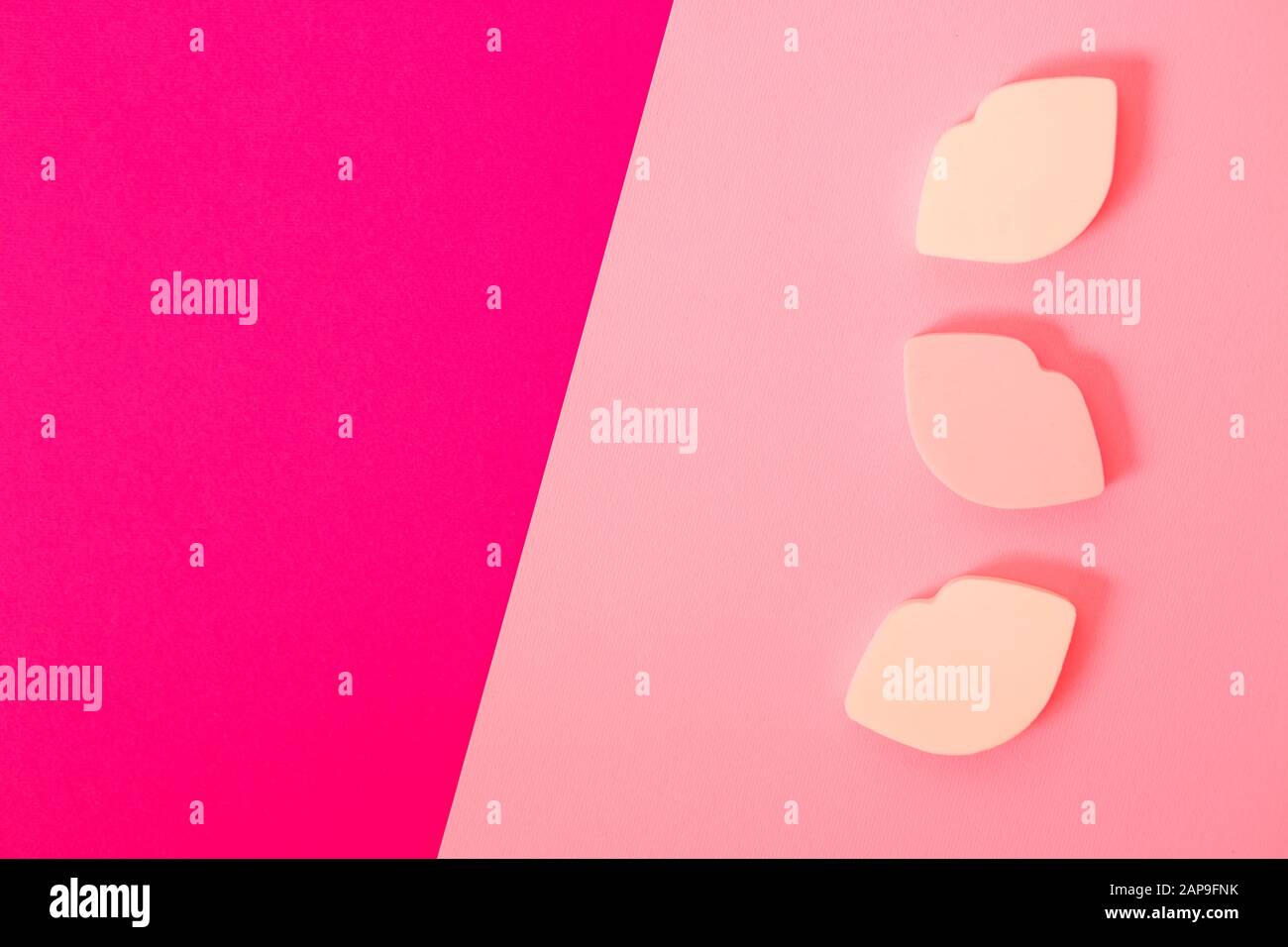Three beautiful sponges on a two tone pink background Stock Photo - Alamy