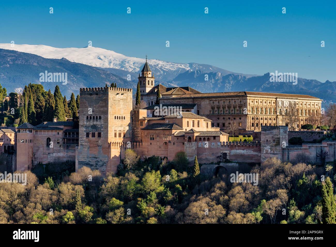 View of Alhambra Palace in Granada, Spain with Sierra Nevada mountains ...