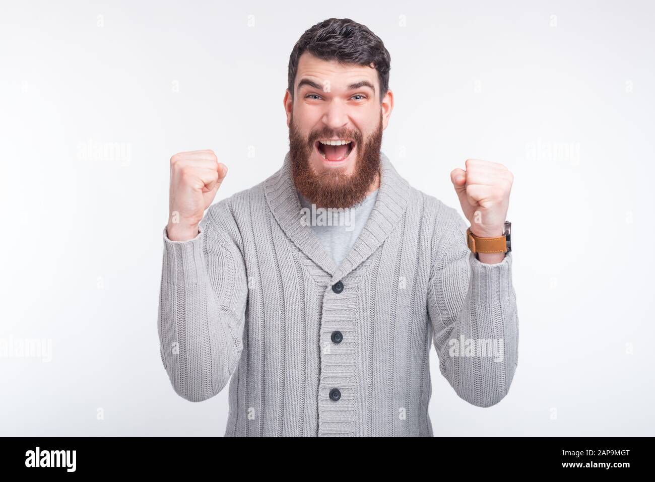 I won Young man is making winner gesture on white background Stock ...
