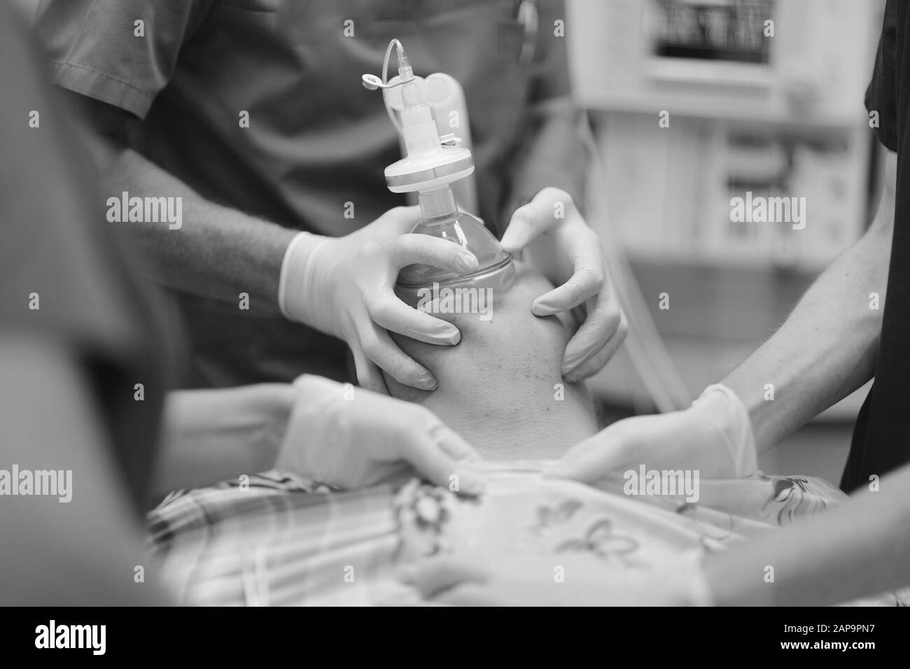 An anesthesiologist leads the patient into general anesthesia before ...