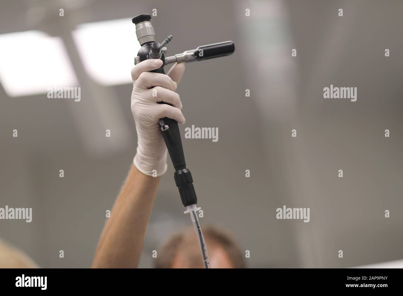 The doctor's hand with a medical endoscope during surgery in the clinic ...