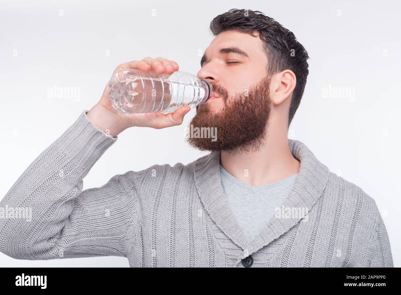 Stay Hidrate. Young man is drinking water from a plastic bottle Stock ...