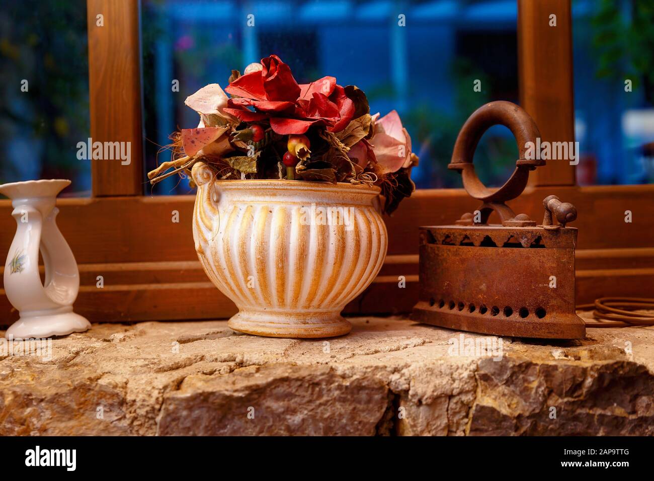 Old iron and vase with flowers on the window Stock Photo - Alamy