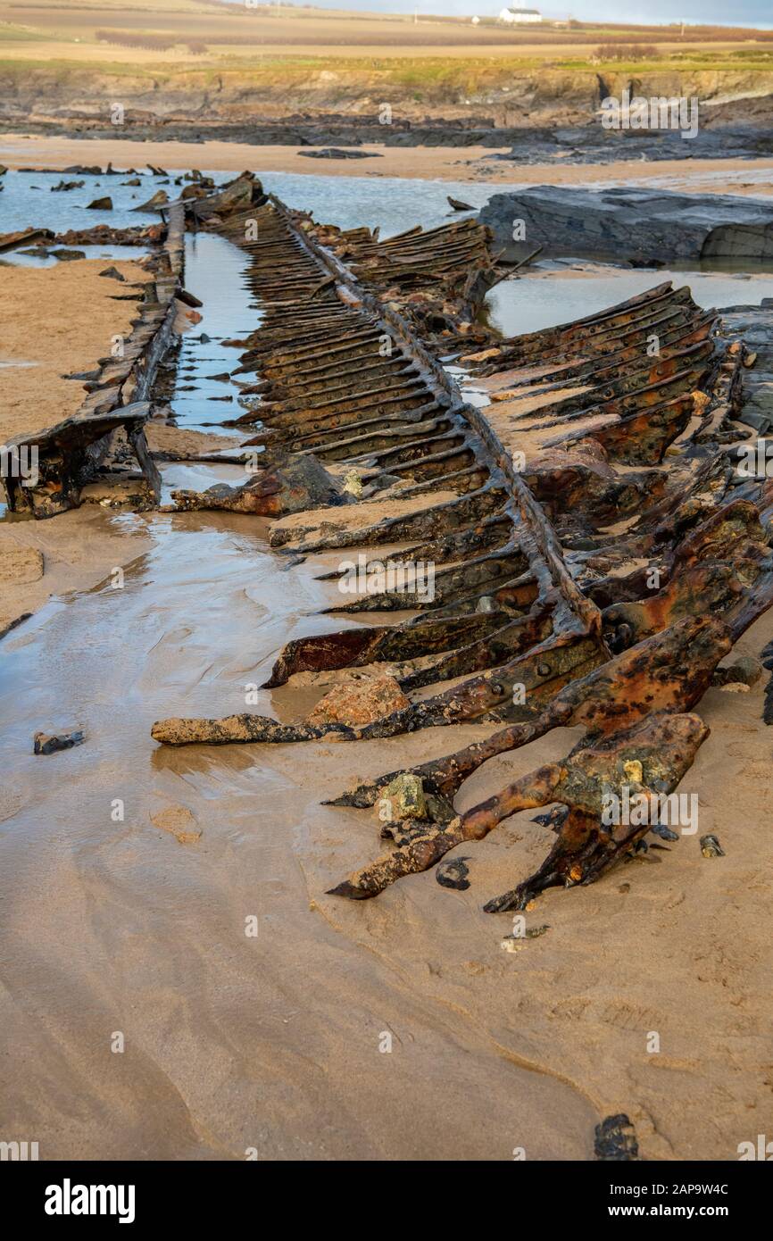 hull of a ship wreck on the beach leading off towards the headland ...