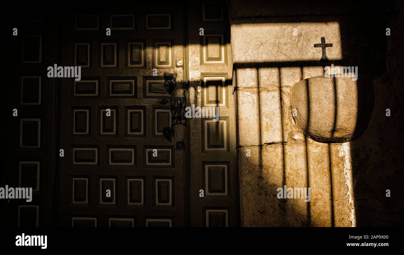 Wood door and holy water stone stoup of San Pedro de Atxarre chapel ...