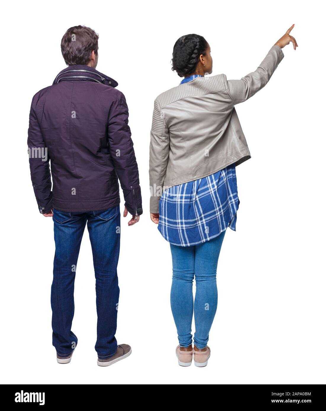 Back view of couple couple in winter jackets pointing. beautiful ...