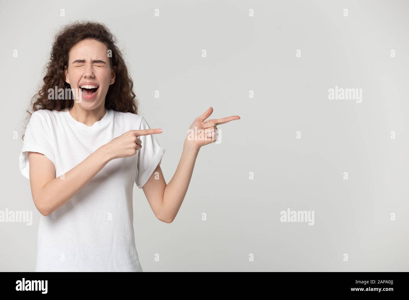 Amazed female customer pointing at empty blank copy space Stock Photo ...