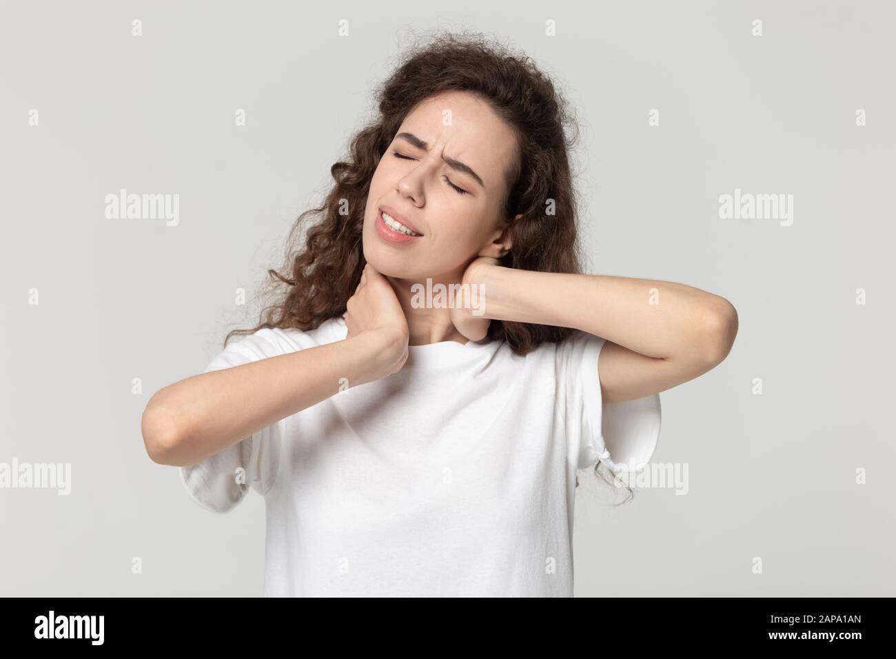 Tired woman suffering from strong terrible neck pain Stock Photo - Alamy