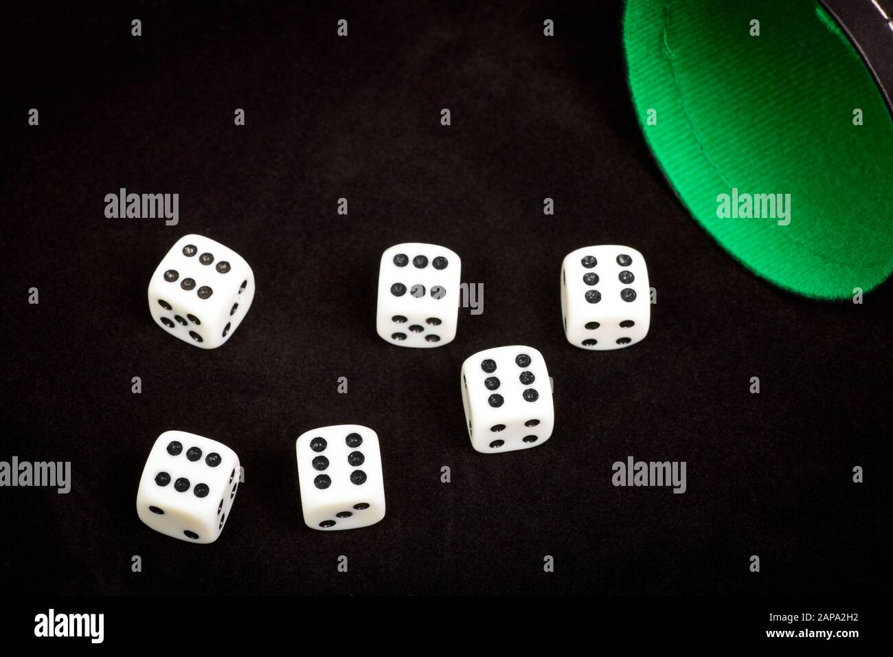 Six dice with number six facing up on black board Stock Photo - Alamy