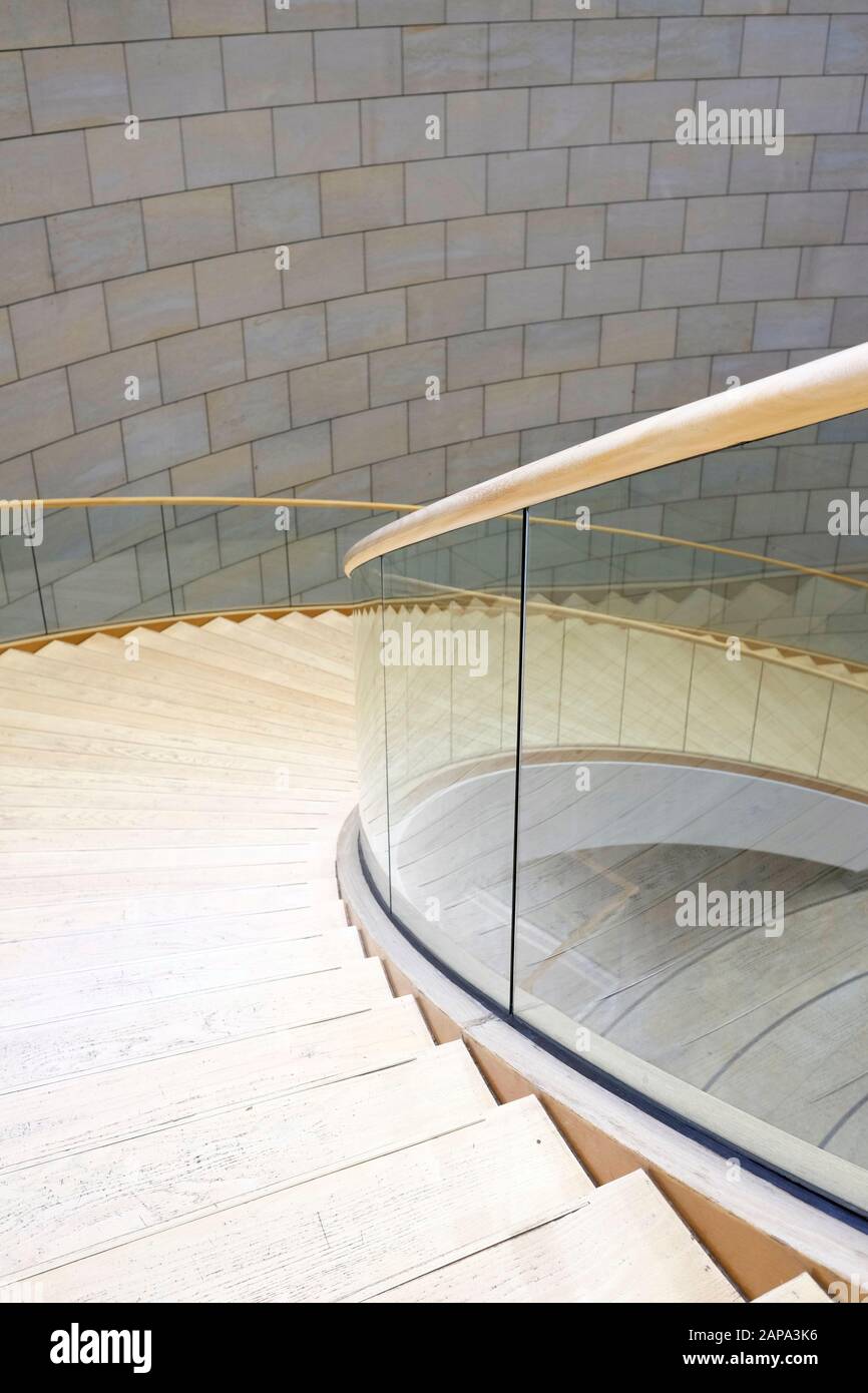Stairs leading downward in front of a concrete wall Stock Photo - Alamy