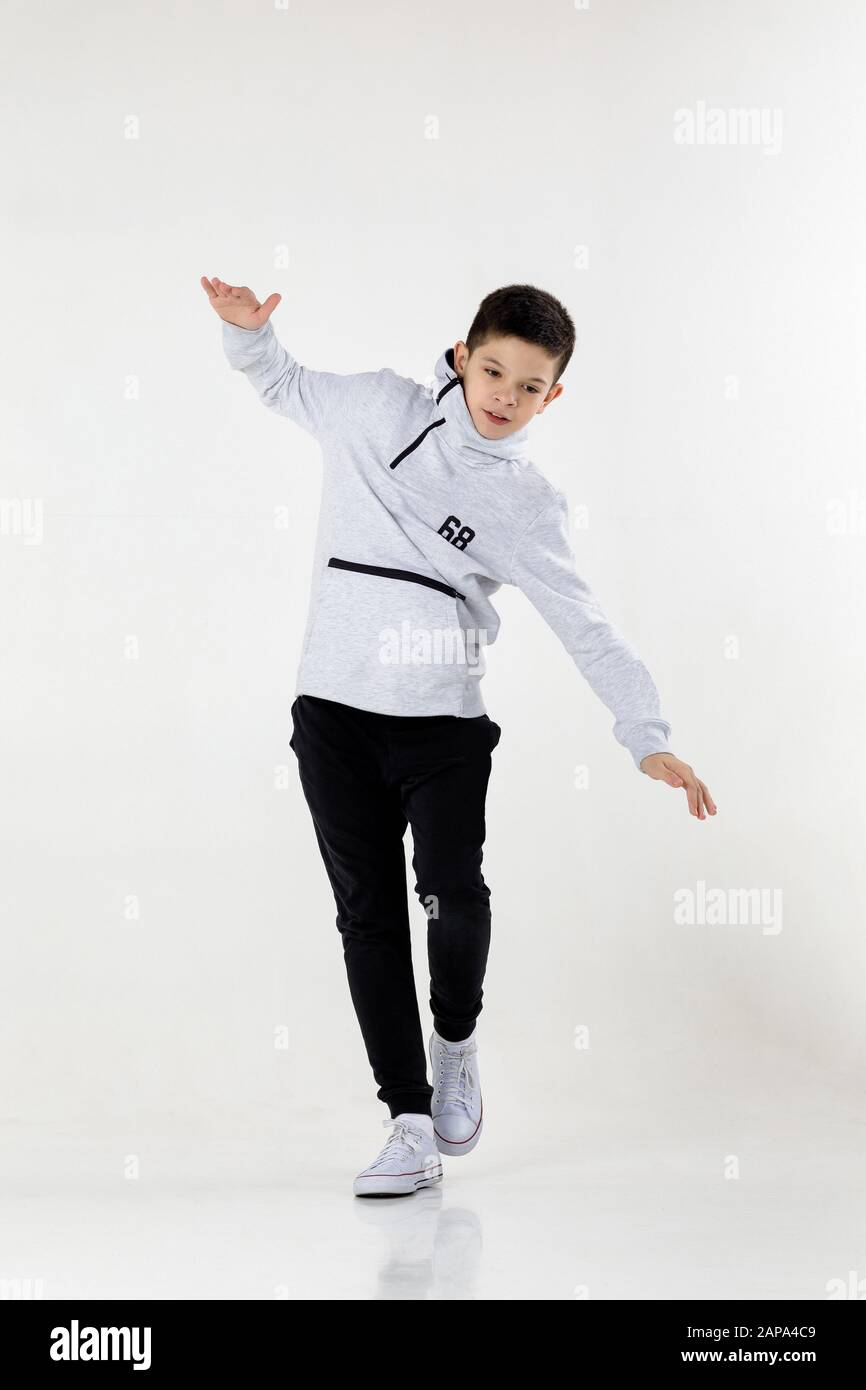 Little hip-hop boy dancing on white studio background Stock Photo - Alamy