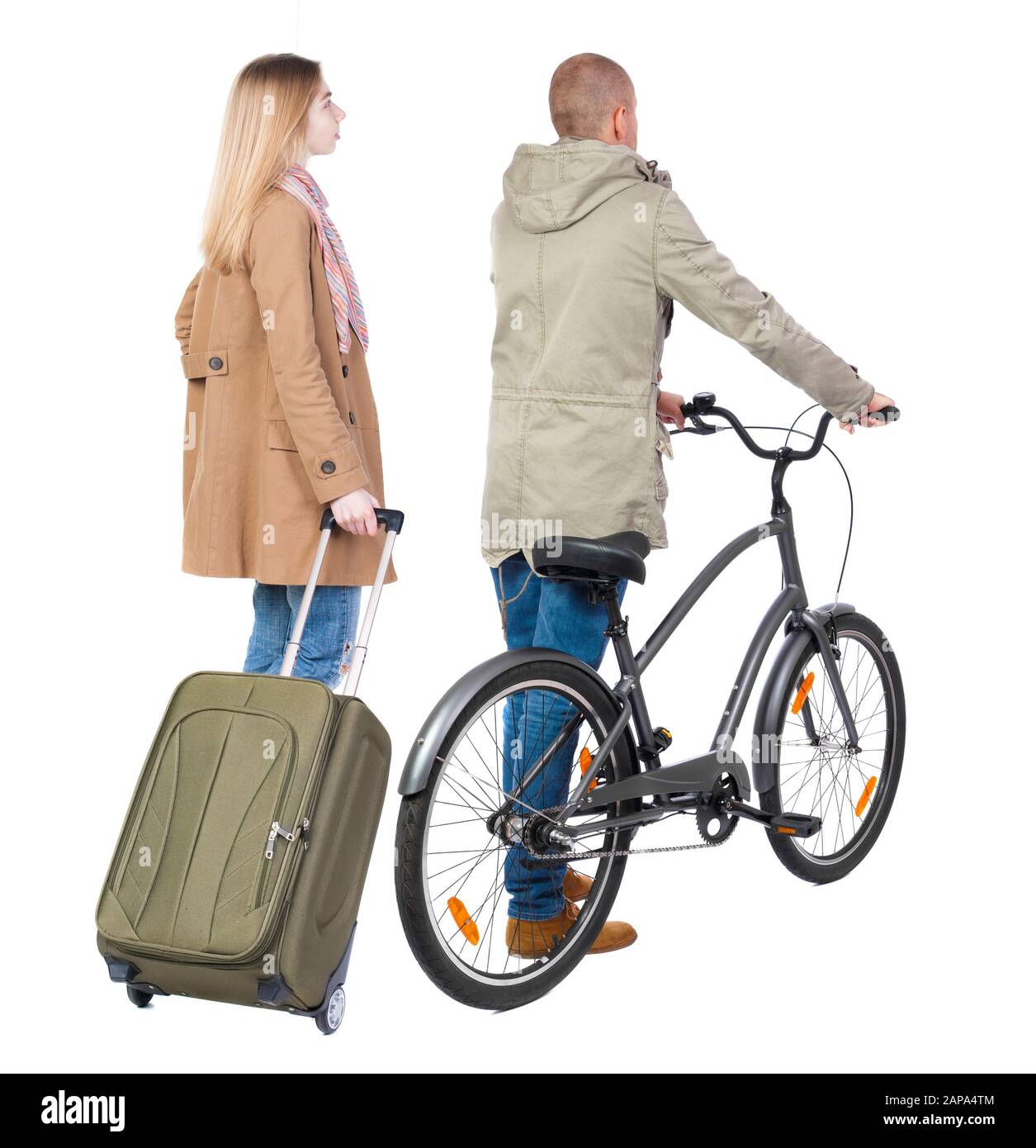 Back view of couple in winter jacket. man on a bicycle and a woman ...