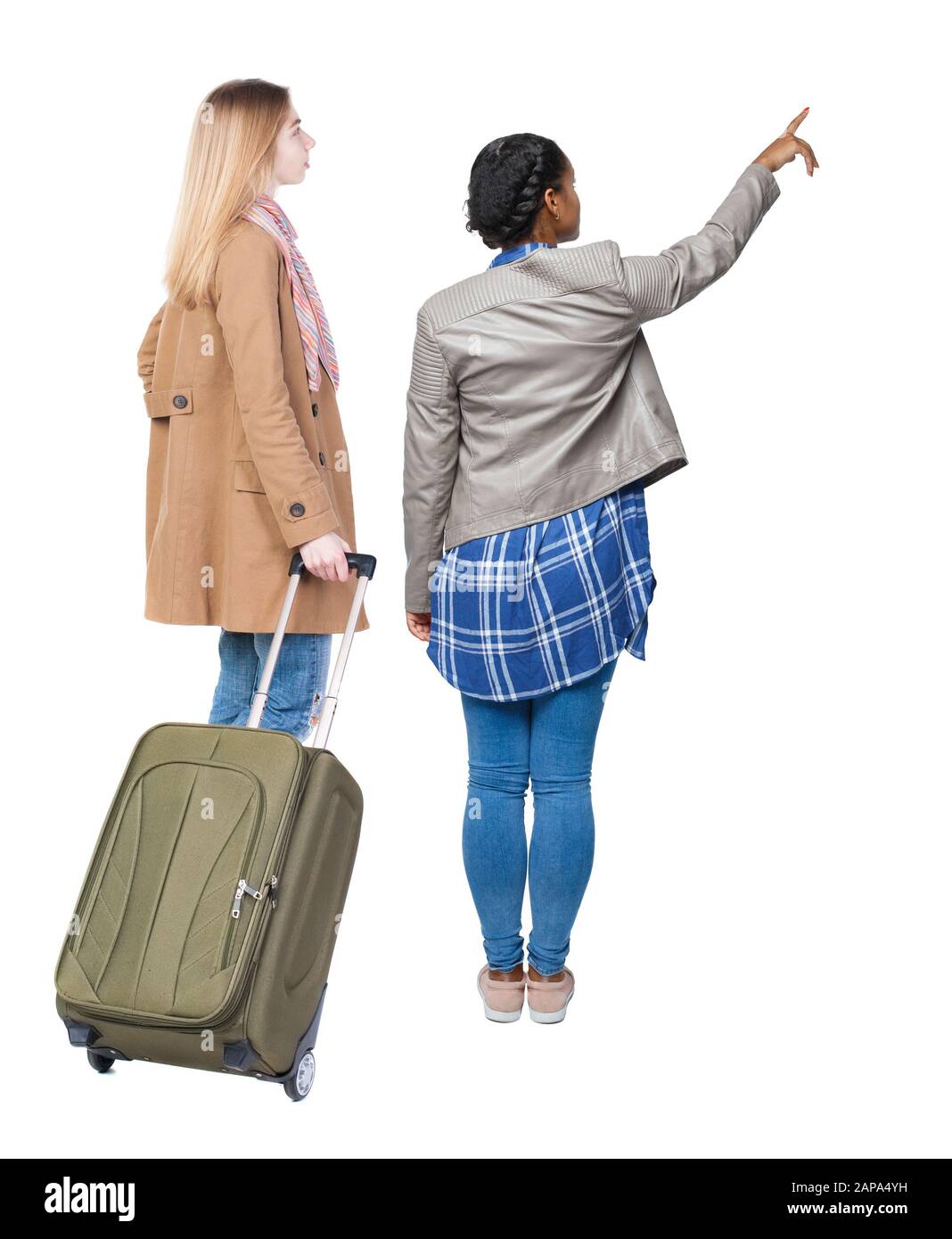 Back view of two woman in winter jacket traveling with suitcas. Back ...