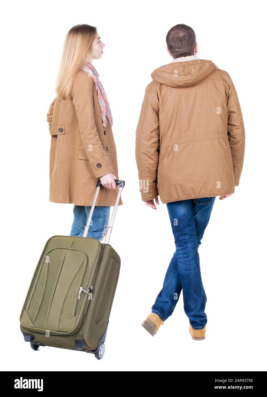 young couple in winter jacket traveling with suitcas. Back view. Rear ...