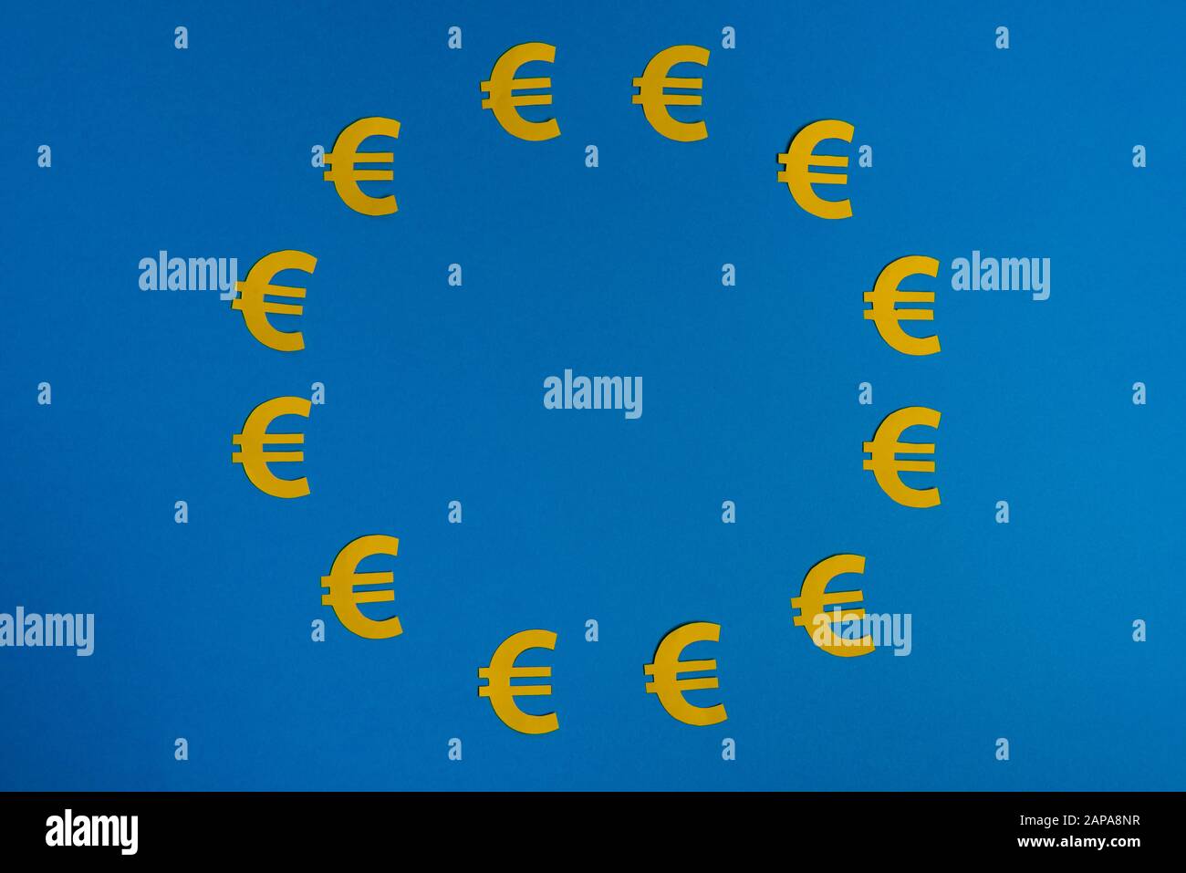 Paper yellow symbols of euro currency on blue background. View from ...