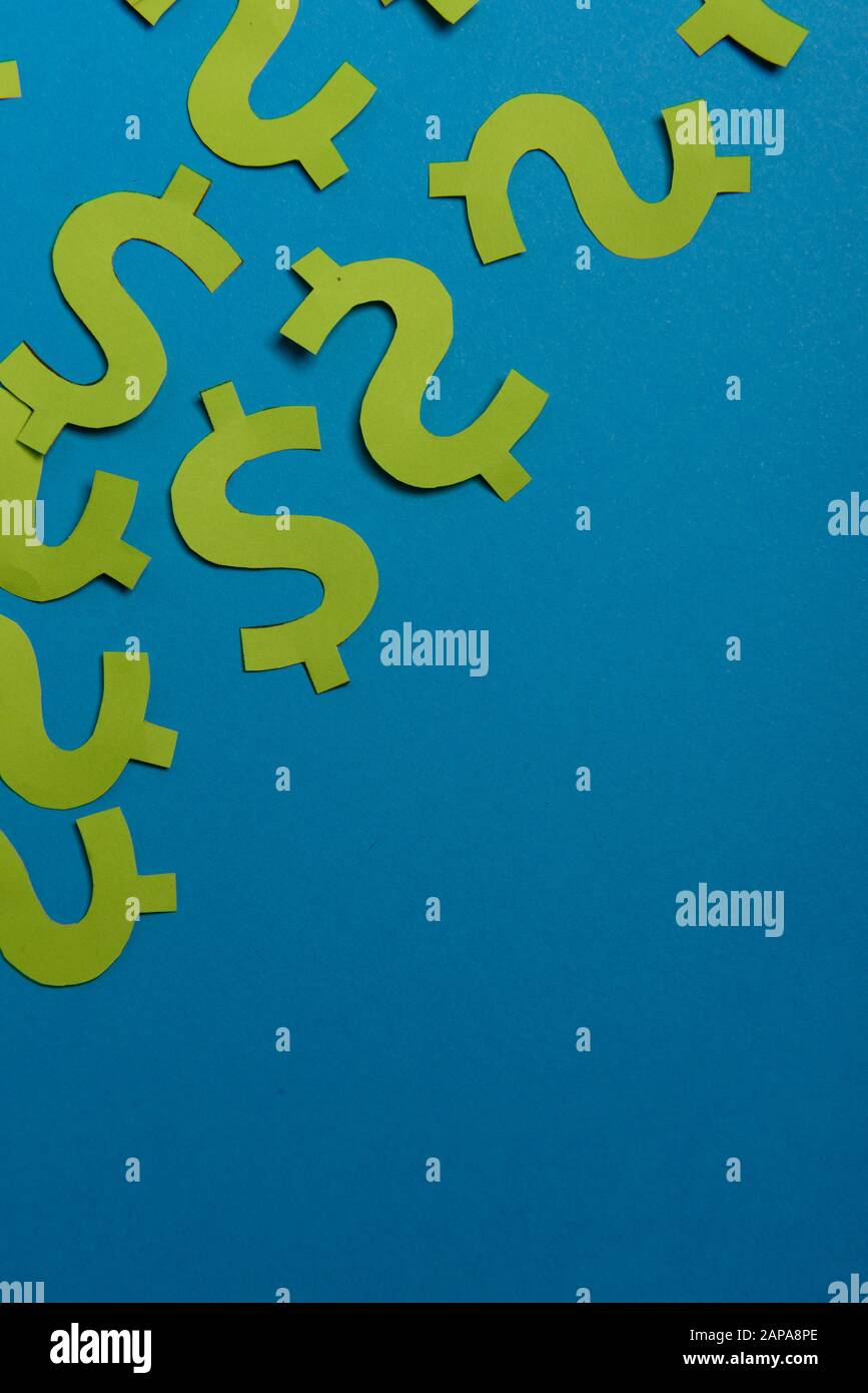 Paper yellow symbols of US dollar currency on blue background. View ...