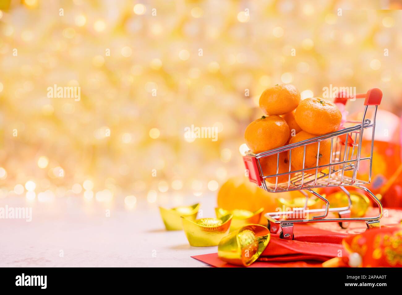 Chinese New Year, Shopping car with orange and China gold ingots ...