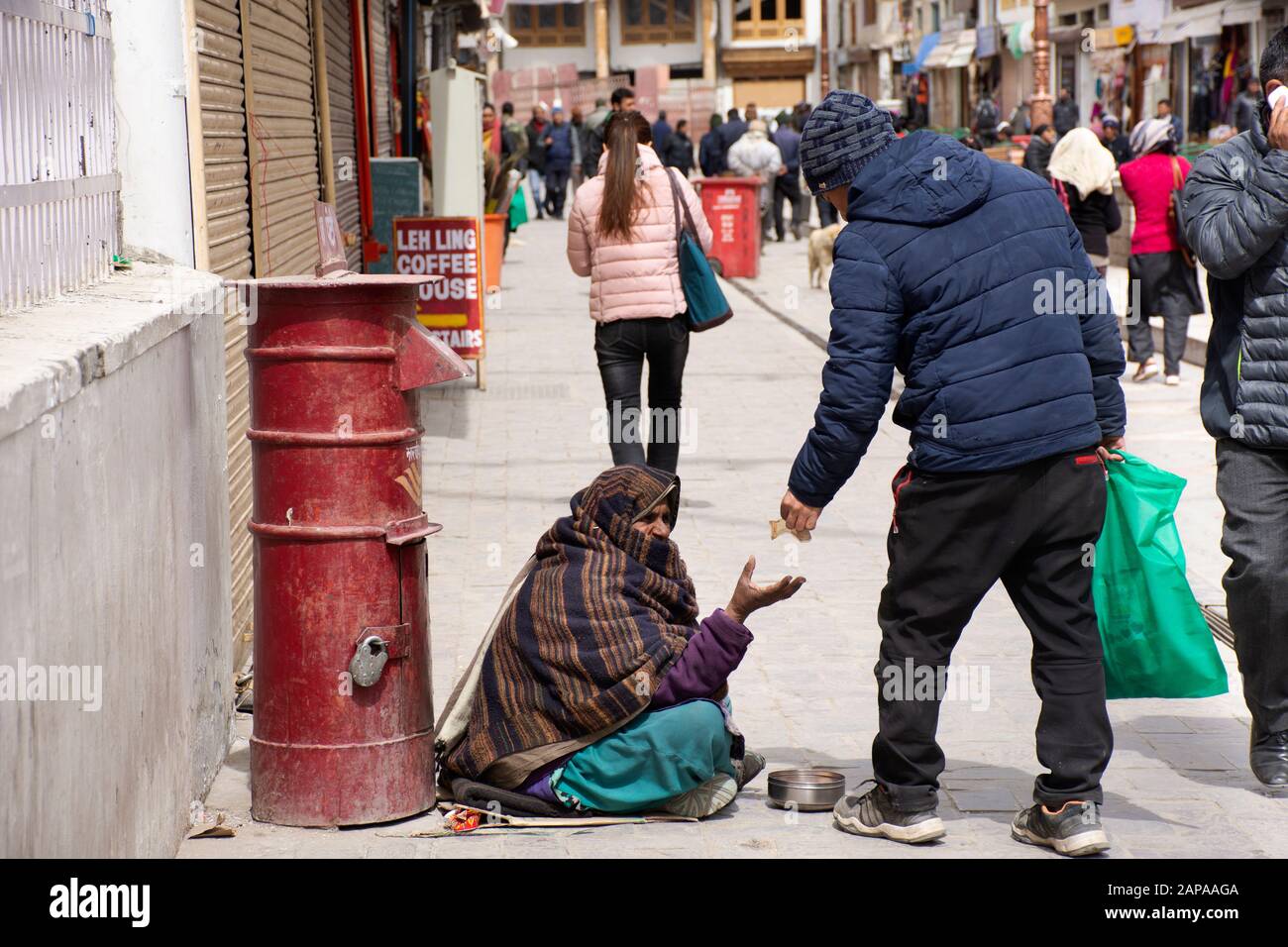JAMMU KASHMIR, INDIA - MARCH 19 : Tibetan people giving money to old ...