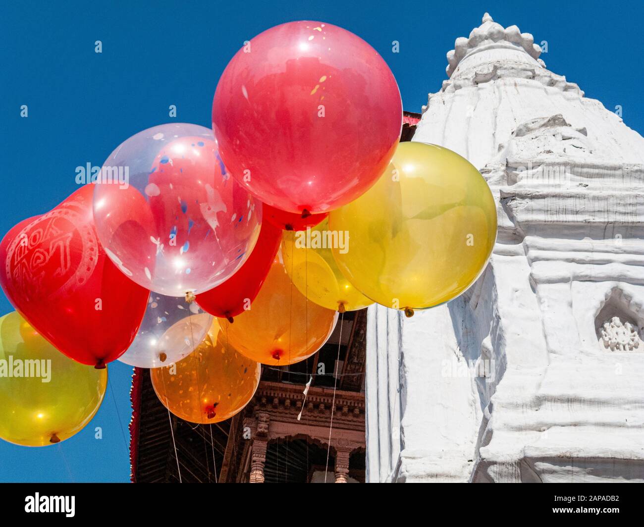 Colorful balloons for sale in front of a white temple Stock Photo - Alamy