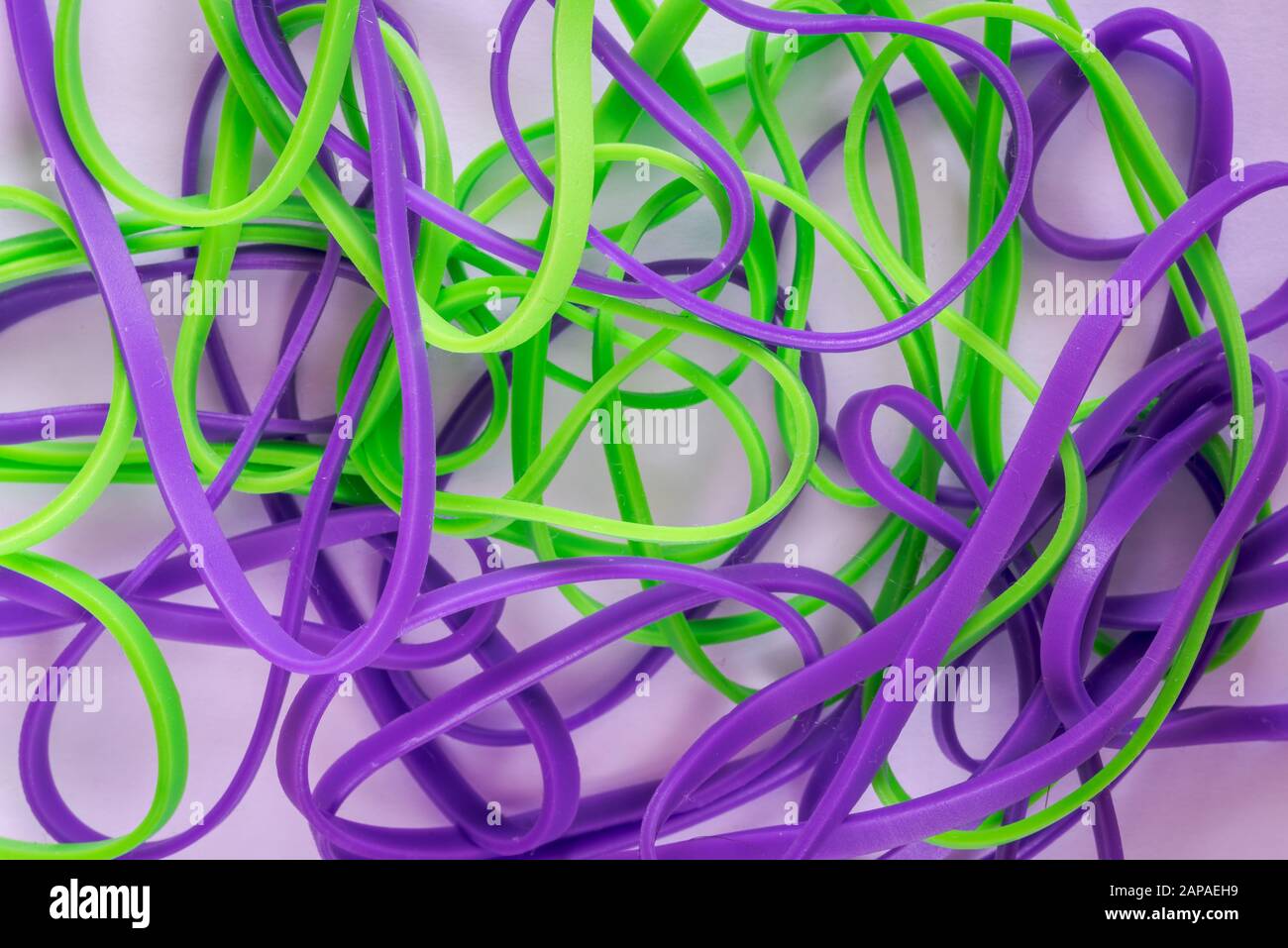 pile of colorful small rubber bands isolated on a white back ground ...
