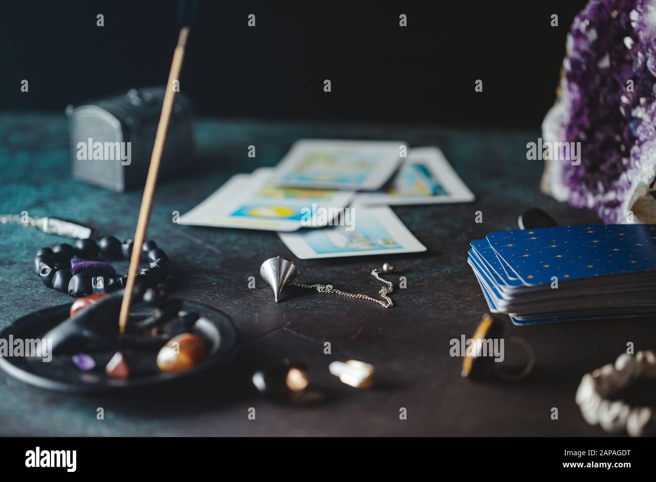 Tarot cards are surrounded magic things on a table.Mystical and occult ...