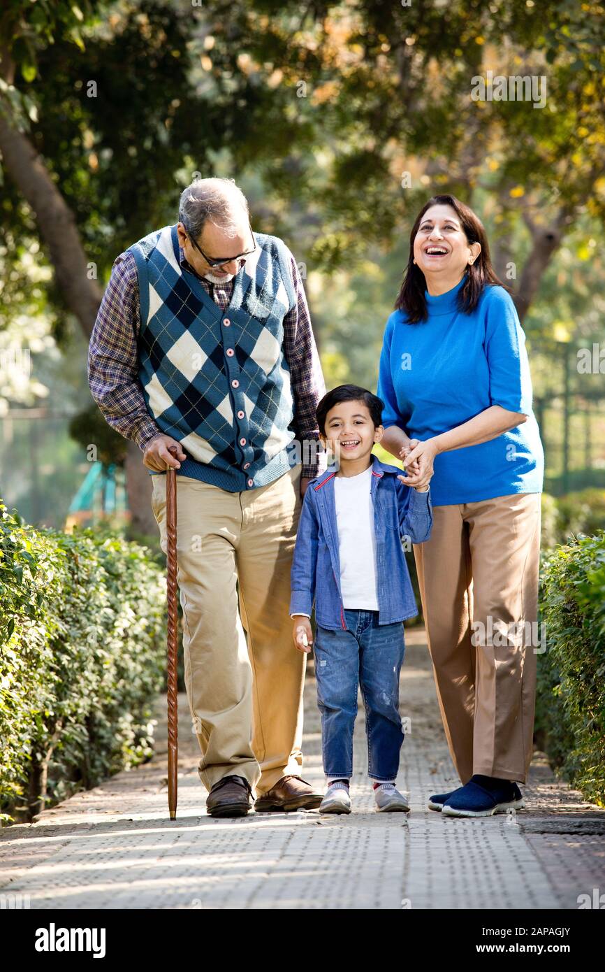 Happy grandparents spending leisure time with little grandson Stock ...