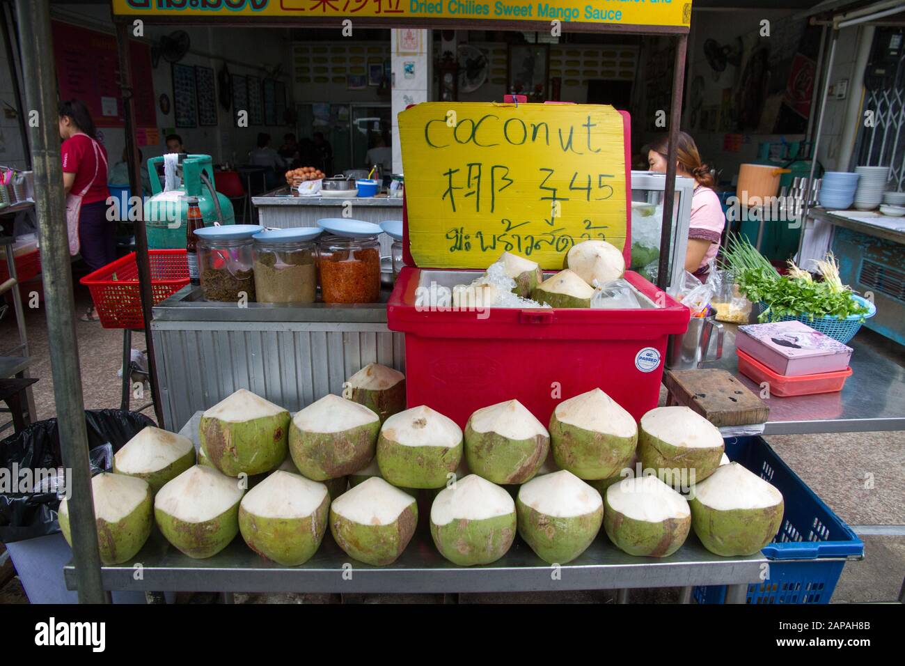 coconuts on ice box displayed for sale in street food stall with price ...
