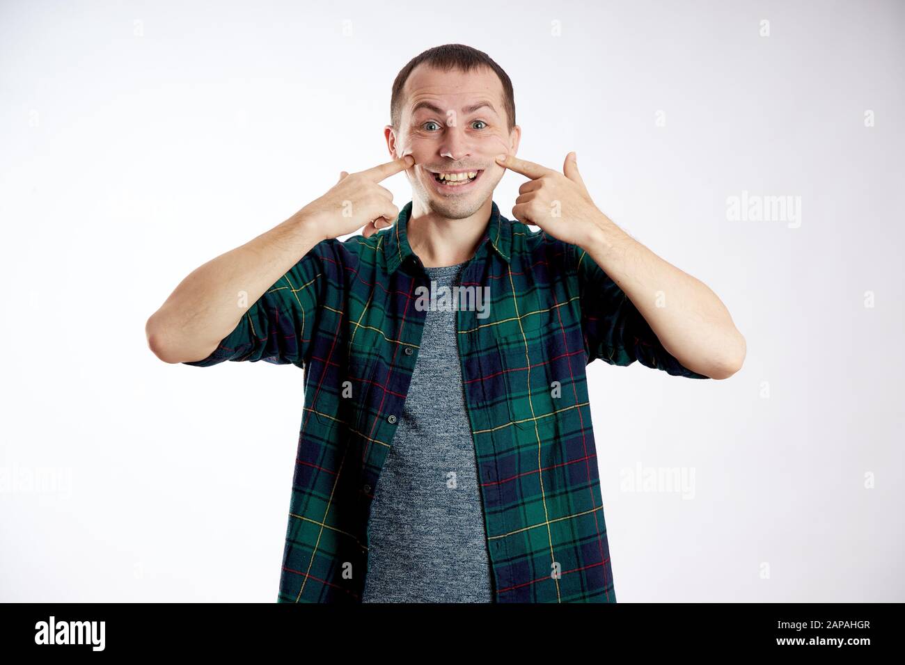 Man smiles, a happy contented face. A guy in a shirt posing Stock Photo ...