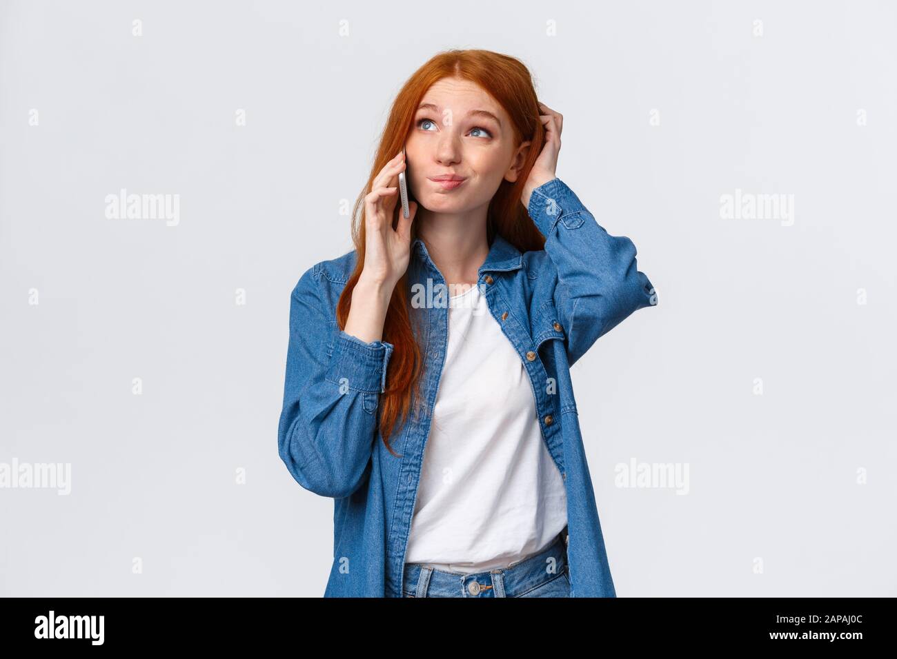 Unsure cute redhead girl troubled give final answer, talking on phone ...