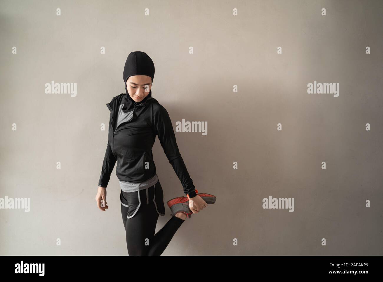 Asian muslim women wearing hijab sportswear doing legs stretching Stock ...