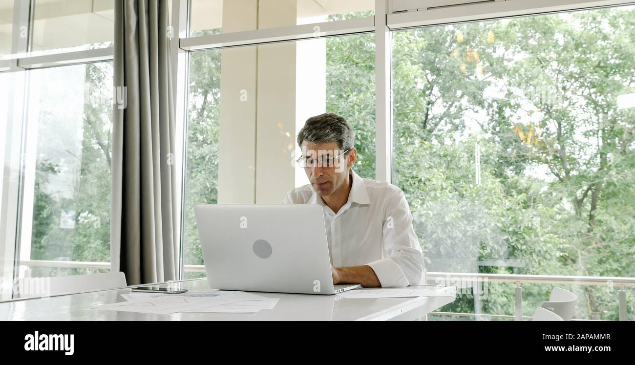 Office worker, businessman uses a laptop computer Stock Photo - Alamy