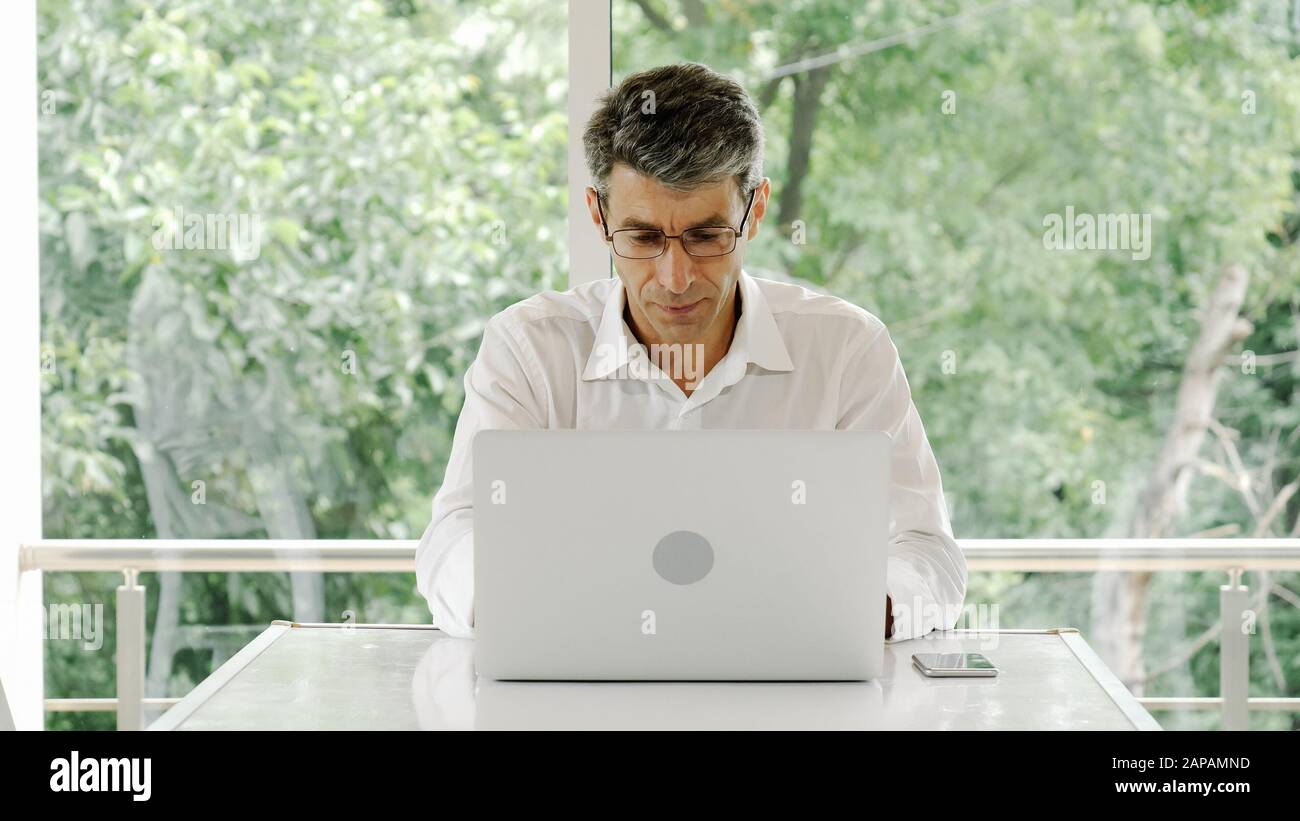Office worker, businessman uses a laptop computer Stock Photo - Alamy